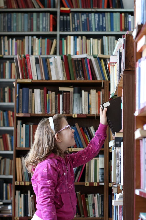 Little girl taking a book stock photo. Image of books - 62833718