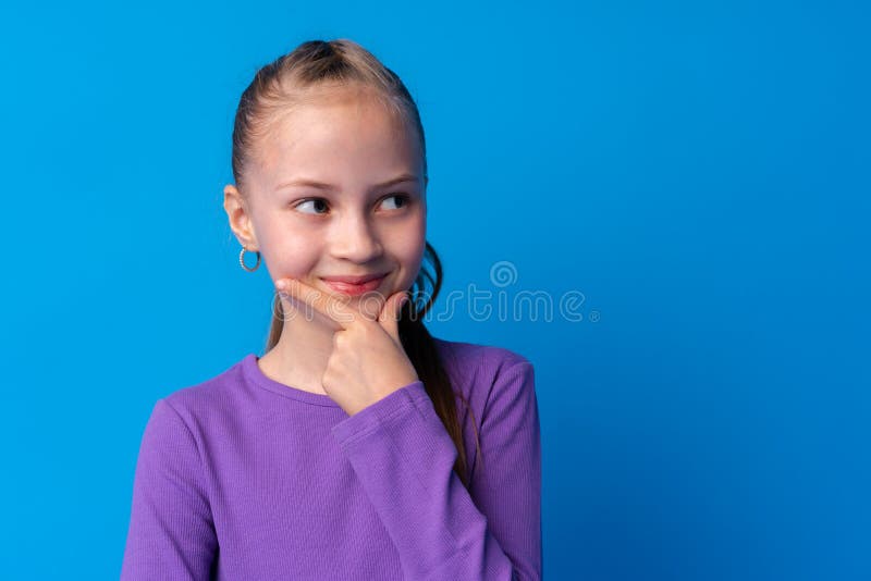 Little Girl Thinking and Looking Up Over Blue Background Stock Photo ...