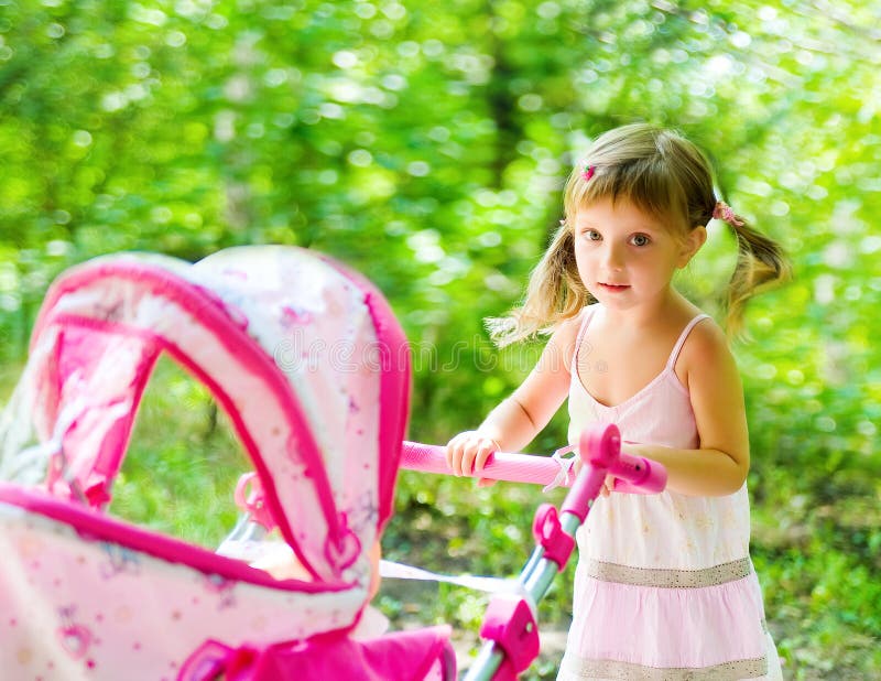Little Girl with Toy Carriage Stock Image - Image of girl, photograph ...
