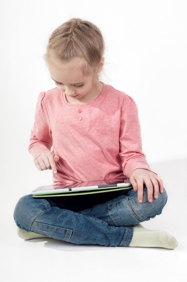 Little Girl Uses a Tablet PC Stock Image - Image of white, little: 56535895