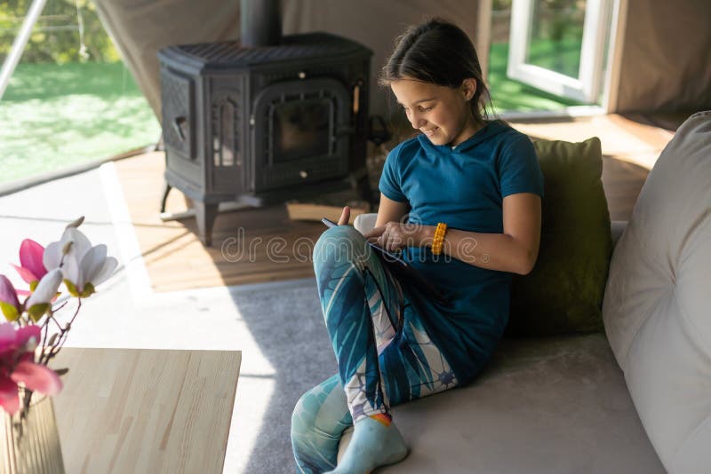 Little Girl Using Tablet Computer at Home. Stock Image - Image of ...