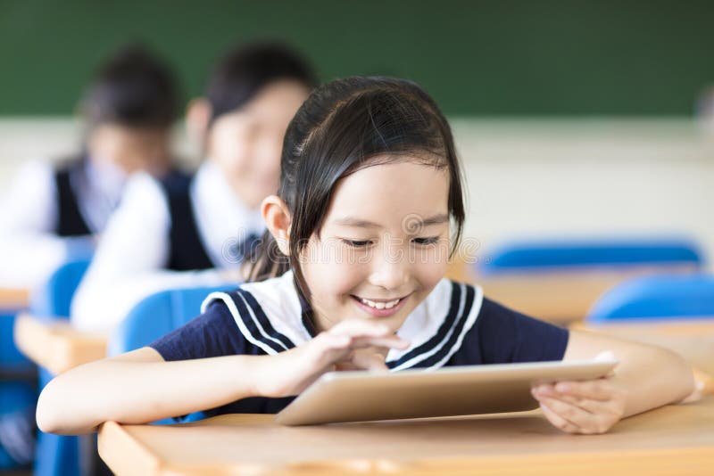 Little Girl Using Tablet Pc in Classroom Stock Image - Image of ...