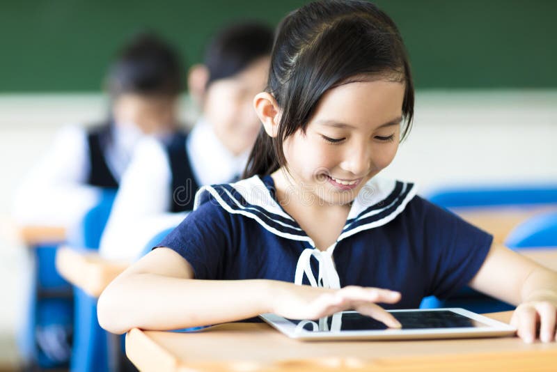 Little Girl Using Tablet Pc in Classroom Stock Image - Image of grade ...