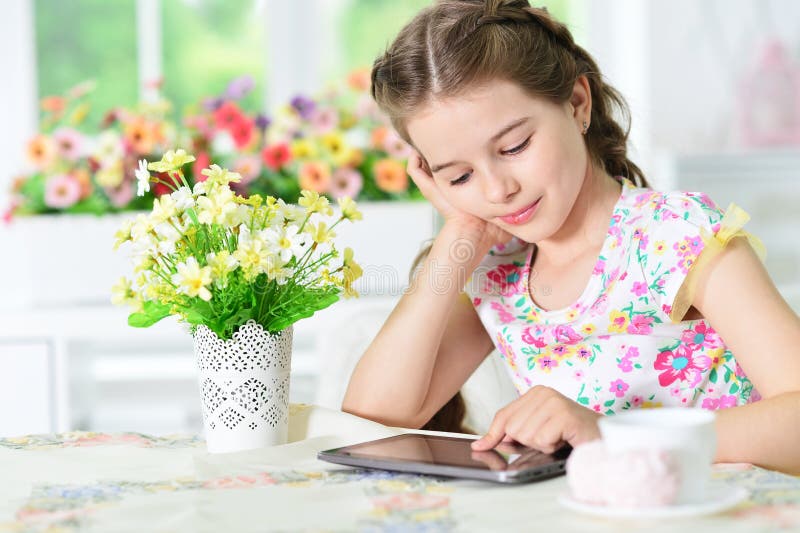 Little girl using tablet stock photo. Image of device - 100282562