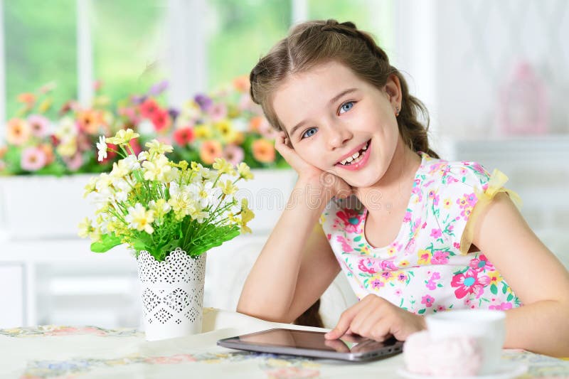 Little girl using tablet stock image. Image of girl, cute - 99336627