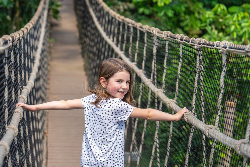 Little Girl Walking on a Suspension Bridge Stock Image - Image of ...