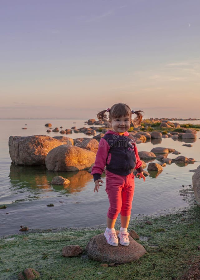 A Little Girl Walks on the Beach during Sunset Stock Photo - Image of ...