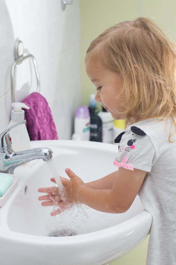 Little girl washing hands stock photo. Image of smile - 43856620