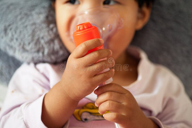 The Little Girl Who is Undergoing Atomization Therapy Stock Image ...
