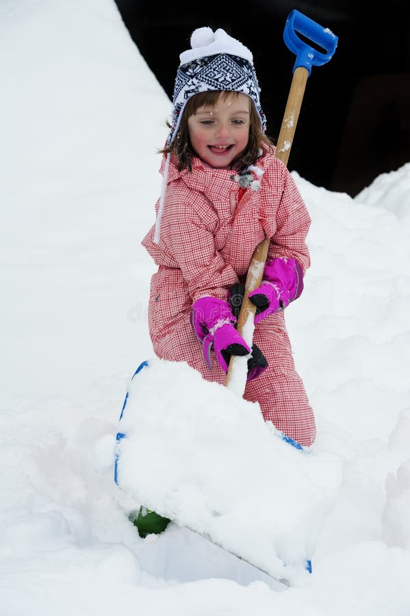 A Little Girl Working with Snow Stock Image - Image of girl, cheerful ...
