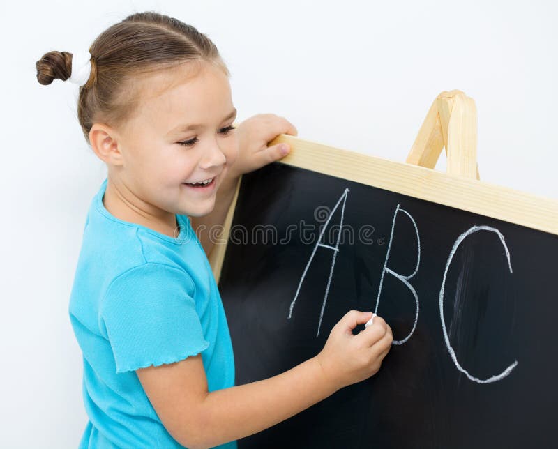 Little Girl is Writing Letters on a Blackboard Stock Image - Image of ...