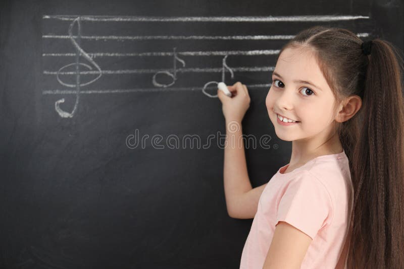 Little Girl Writing Music Notes on Blackboard Stock Photo - Image of ...