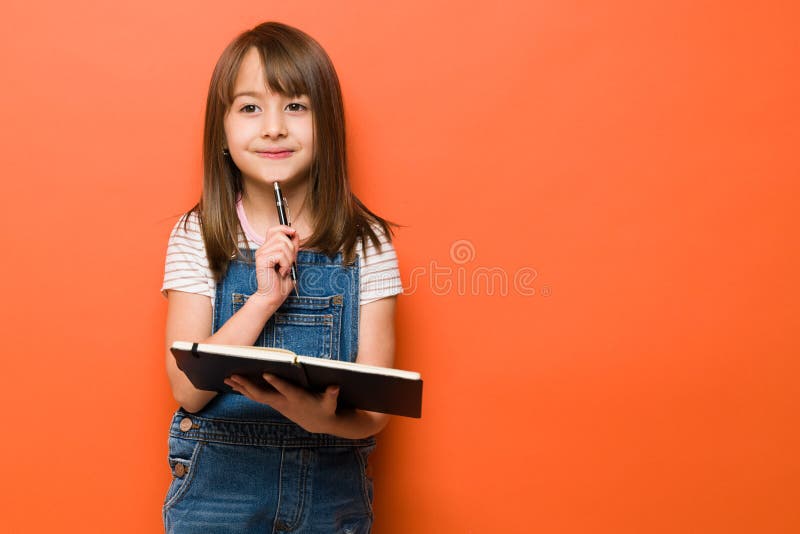 Little Girl Writing on a Notebook Stock Photo - Image of children ...
