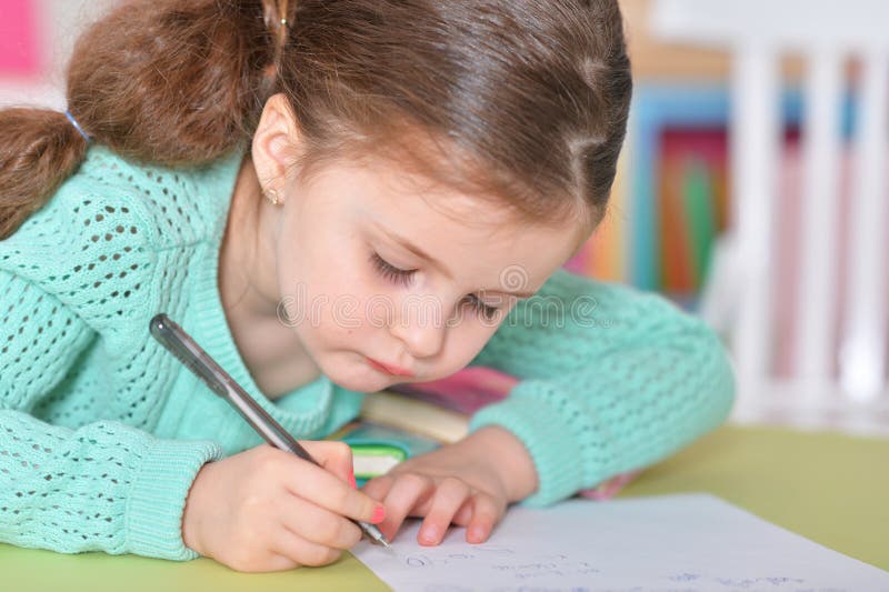 Little Girl Writing while Sitting at Table Stock Photo - Image of learn ...