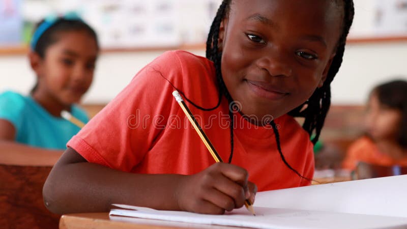 Little Girl Writing and Smiling at Camera during Class Stock Footage ...