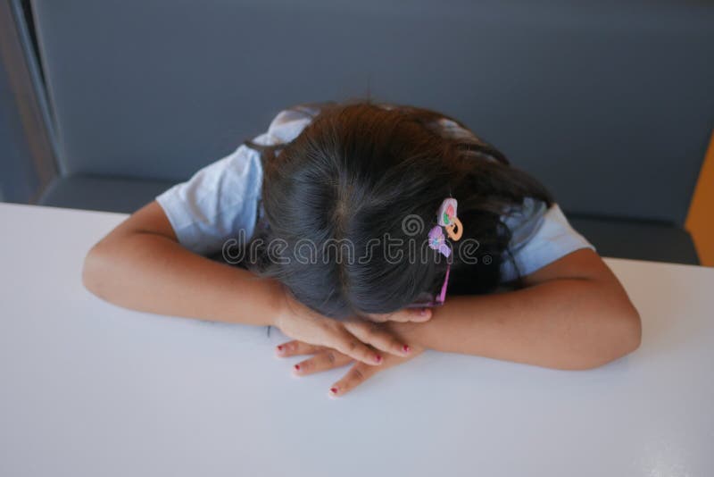 Little Girl Y Head Down on Desk Stock Photo - Image of alone, tired ...