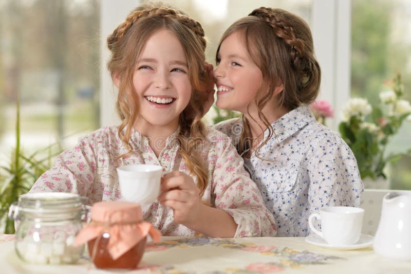 Little girls drinking tea stock photo. Image of family - 73042604