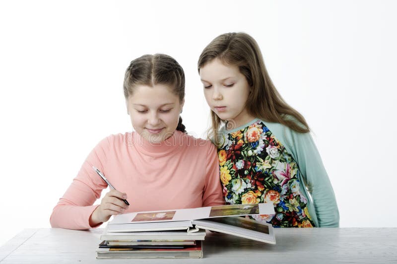 Little Girls Read Books at the Table on White Stock Photo - Image of ...