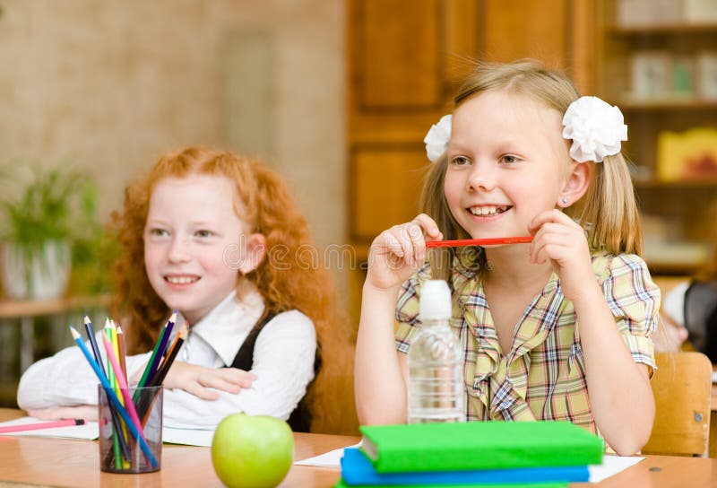 Little Girls Sitting and Studying at School Stock Photo - Image of book ...