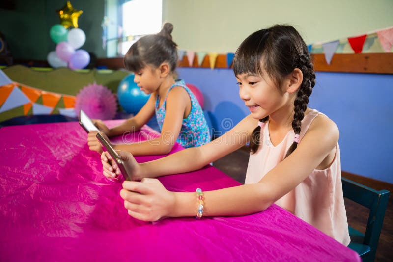 Little Girls Using Tablet at Party Stock Photo - Image of house ...