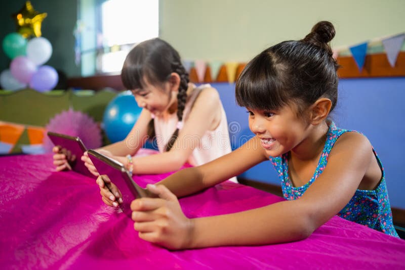 Little Girls Using Tablet at Party Stock Image - Image of abode, global ...