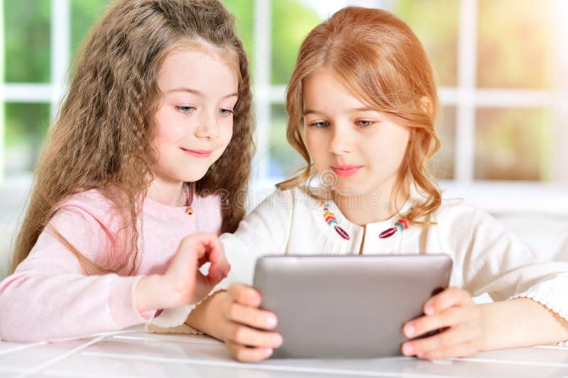 Little girls using tablet stock photo. Image of vitality - 99380408