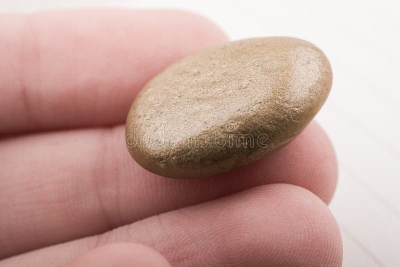 Little Gold Color Pebble in Hand Stock Photo - Image of stone, natural ...