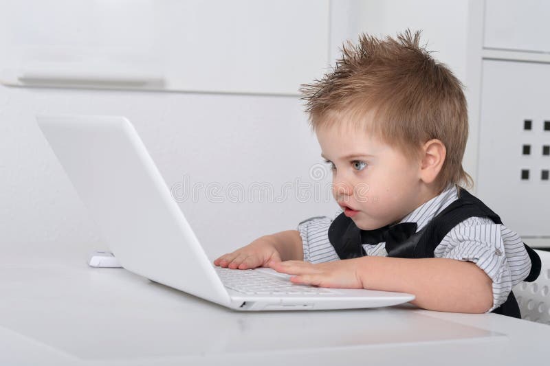 Little Handsome Boy Sits with a Computer Stock Image - Image of face ...