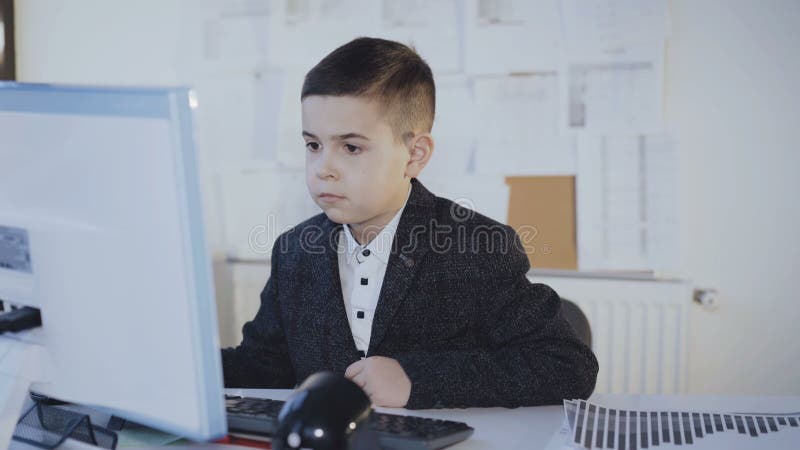 Little Handsome Boy Working with Computer in Office. 4K Stock Video ...