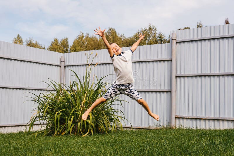 Little Happy Boy Jumping in Garden. Stock Photo - Image of playful ...