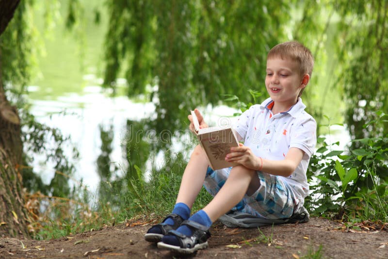 Little Happy Boy Reading Book. Stock Image - Image of literature, green ...