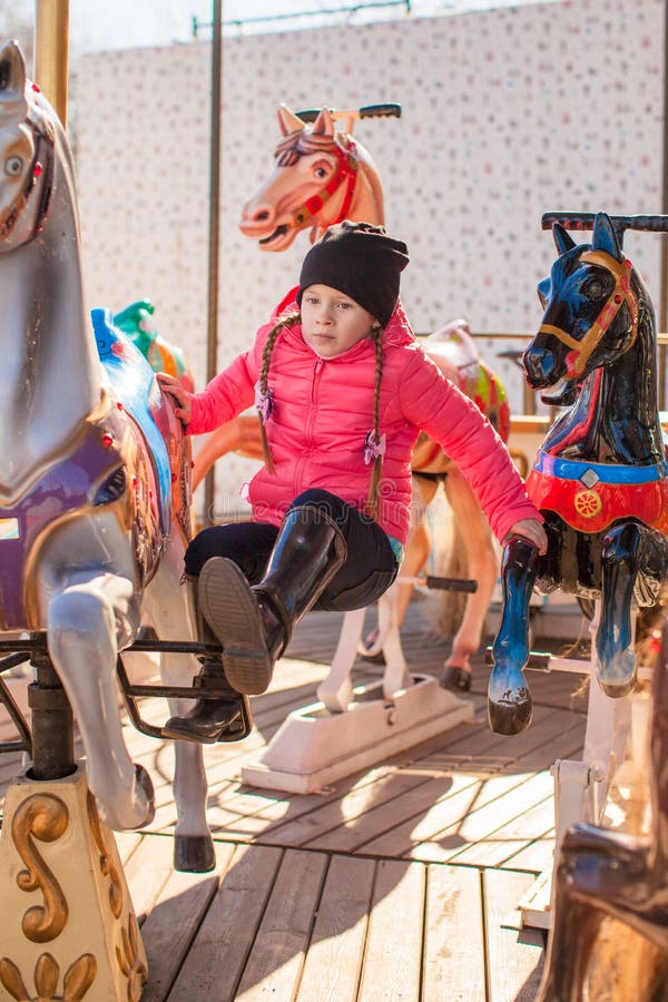 Little Happy Girl on Carousel at an Amusement Park Stock Photo - Image ...