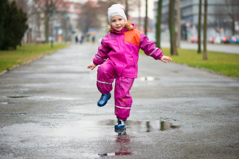 Little Happy Girl Jumping in Puddle Stock Image - Image of boots, play ...