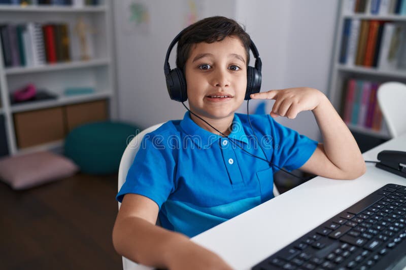 Little Hispanic Boy Using Computer Laptop at the School Smiling Happy ...