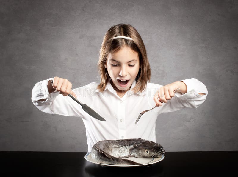 Little Hungry Girl in Front of a Whole Raw Fish Stock Photo - Image of ...