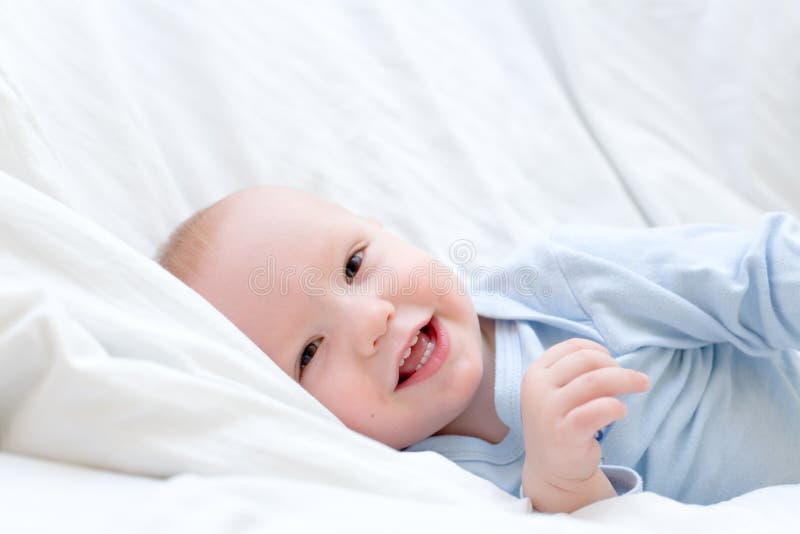 Little Joyful Baby Resting on Bed Stock Photo - Image of face ...
