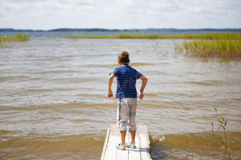 Little Kid Alone on a Wooden Lake Pier Stock Photo - Image of beach ...