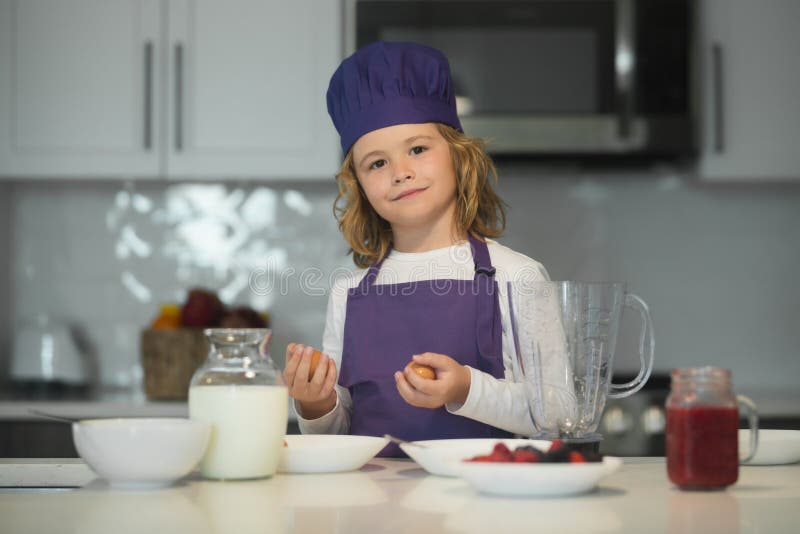 Little Kid Boy in Chef Hat and an Apron Cooking in the Kitchen. Stock ...