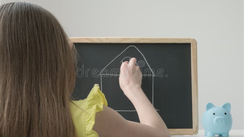 Little Kid Girl Draw House on Desk with Chalk. Childhood Mortgage Dream ... Little Kid Girl Draw House on Desk with Chalk. Childhood Mortgage Dream ...