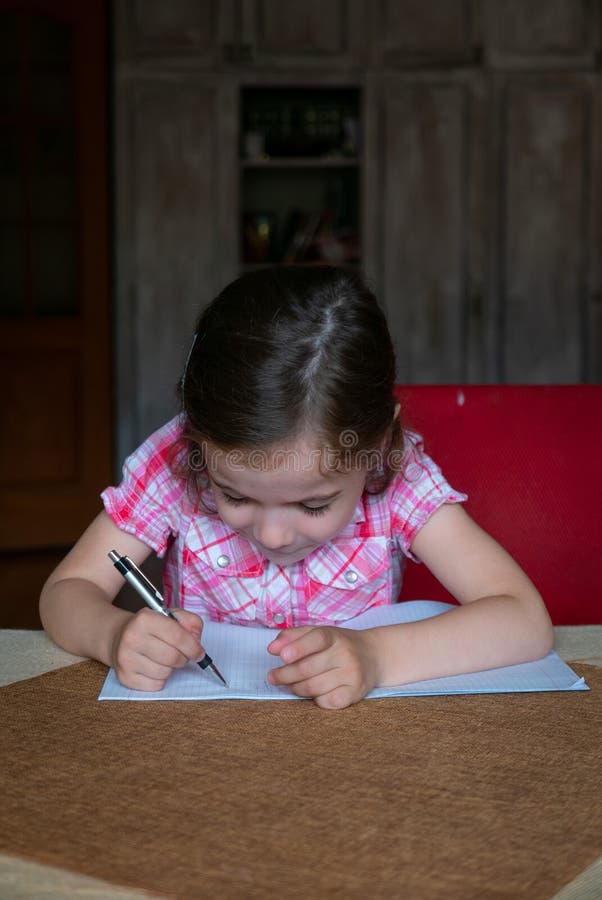 Little Kid Girl Makes Homework with Pen and Paper Notebook Stock Photo ...