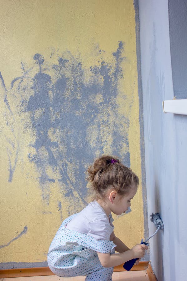 Little Kid Girl Paints Wall by Paint Roller Stock Photo - Image of ...