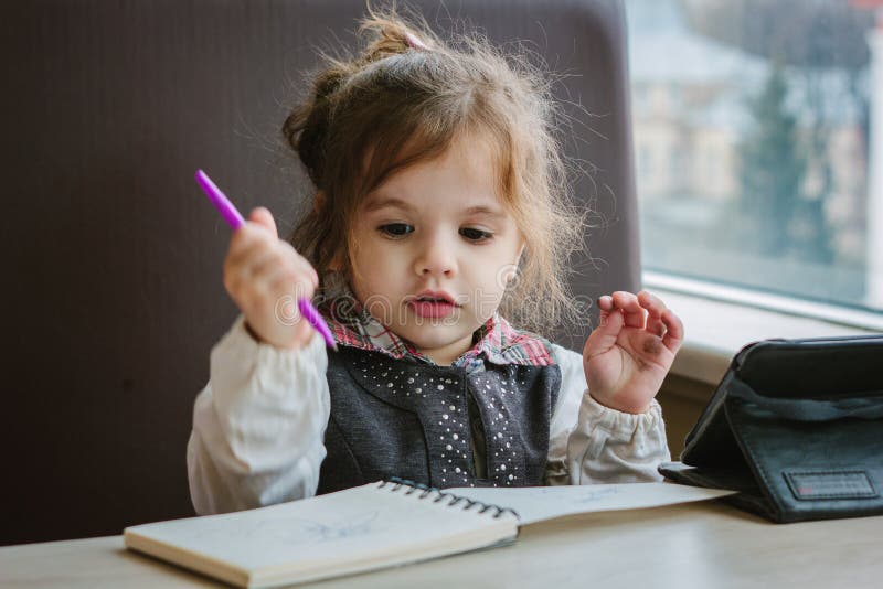 Little Kid Girl Writing or Drawing with Pen in Scetch Book Stock Photo ...