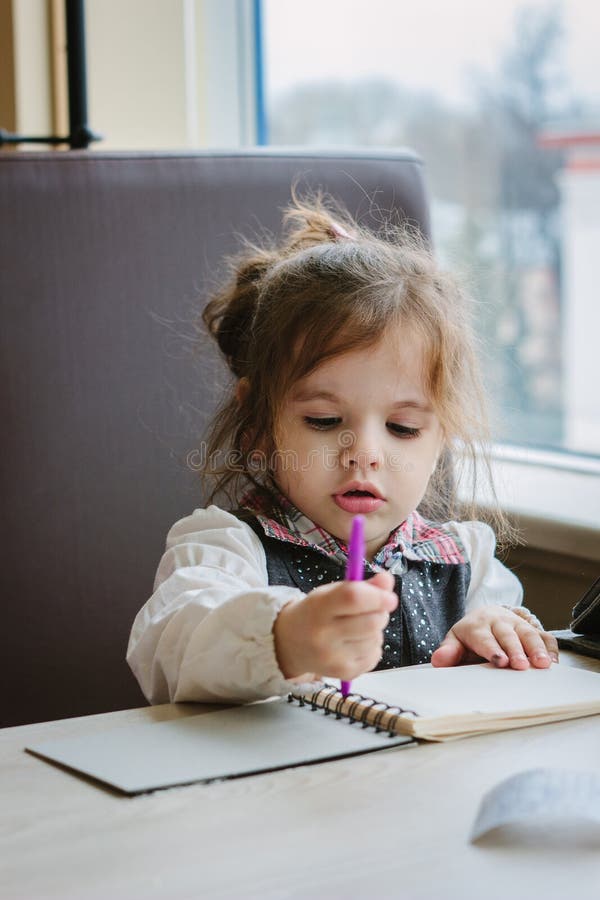Little Kid Girl Writing or Drawing with Pen in Scetch Book Stock Image ...
