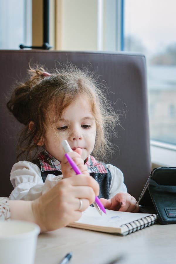 Little Kid Girl Writing or Drawing with Pen in Scetch Book Stock Image ...