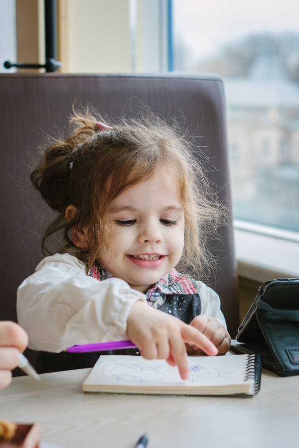 Little Kid Girl Writing or Drawing with Pen in Scetch Book Stock Image ...