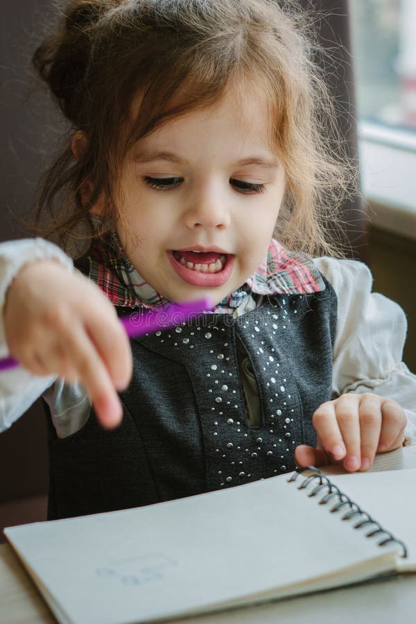 Little Kid Girl Writing or Drawing with Pen in Scetch Book Stock Image ...