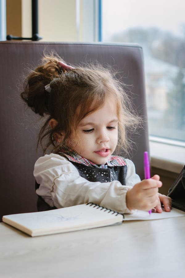 Little Kid Girl Writing or Drawing with Pen in Scetch Book Stock Photo ...