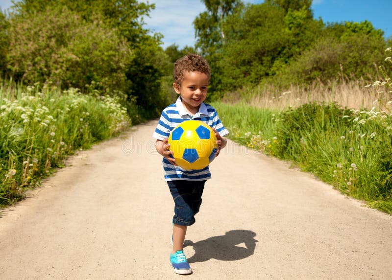 Little Kid Holding a Ball stock photo. Image of child - 26078192