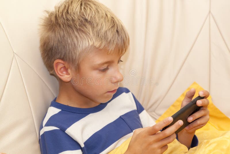 Little Kid Playing Game or Watching Something on Mobile Smart Phone ...