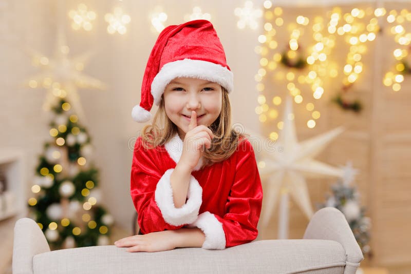 Little Kid in Santa Costume Doing Silencing Gesture Stock Photo - Image ...